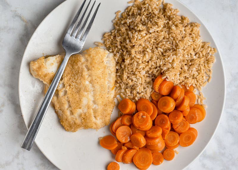 Baked Cod with a Side of Carrots and Brown Rice Stock Image - Image of ...