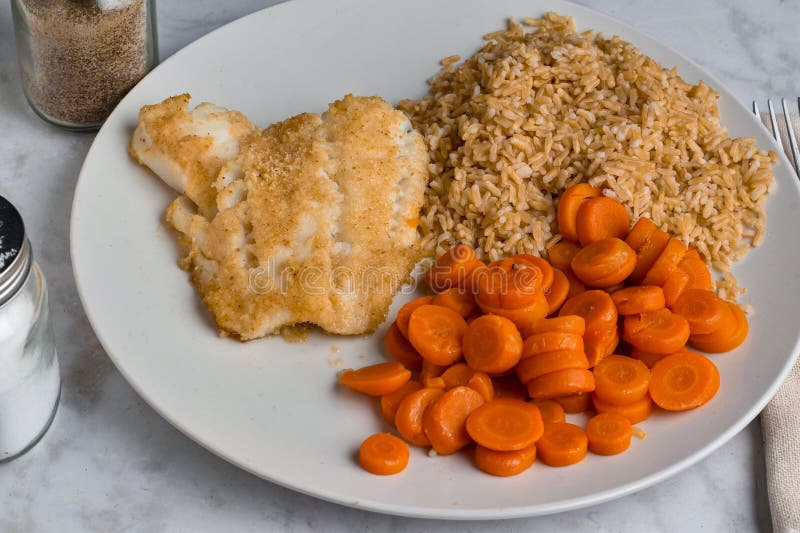 Baked Cod Served with Brown Rice and a Side of Carrots Stock Image ...