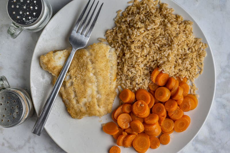 Baked Cod with a Side of Carrots and Brown Rice Stock Photo - Image of ...