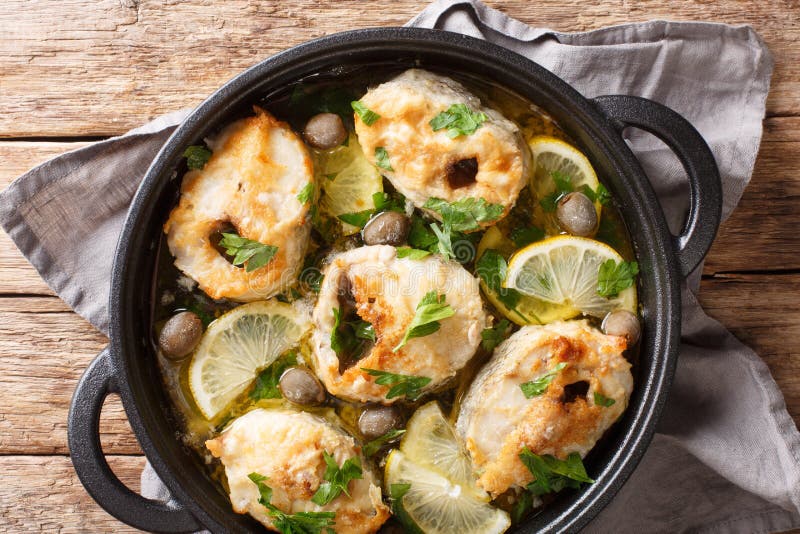 Baked Cod Steaks with Lemon and Olives Closeup in a Pan. Horizontal Top ...