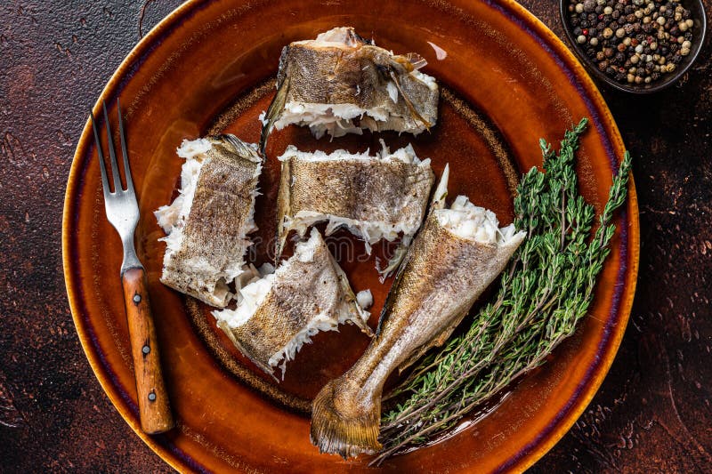 Baked Cod White Fish in a Plate. Dark Wooden Background Stock Photo ...