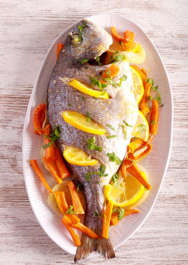 Baked Dorada Sea Bream Fish with Lemon Stock Image - Image of carrot ...