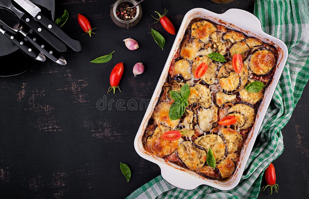 Baked Eggplant With Cheese On A Dark Wooden Table Parmigiana Melanzane
