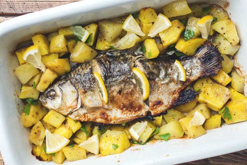 Baked Fish Carp with Potatoes in a Ceramic Pan. Rustic Style Stock ...