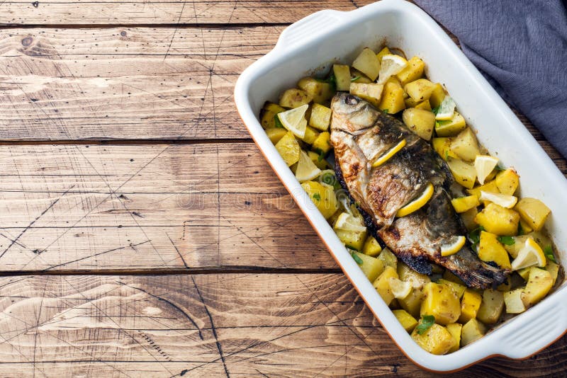 Baked Fish Carp with Potatoes in a Ceramic Pan. Rustic Style. Copy ...