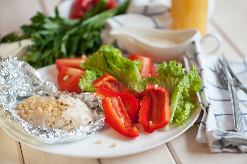Baked fish with pine nuts stock image. Image of sauce - 94257423