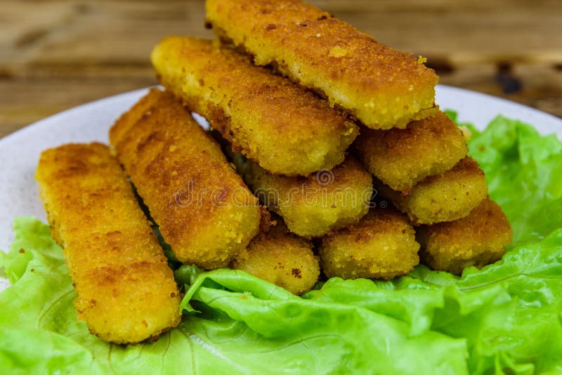 Baked Fish Sticks and Lettuce Leaves in a Plate Stock Image - Image of ...