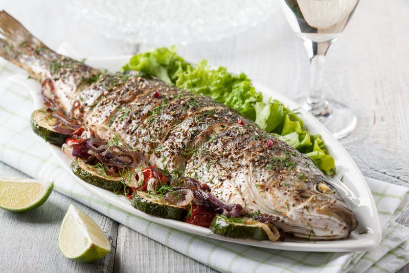 Baked fish with vegetables stock image. Image of dinner - 56397635