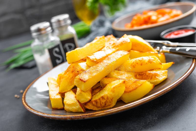 Baked, Fried Potato on Plate on Table Stock Image - Image of brown ...