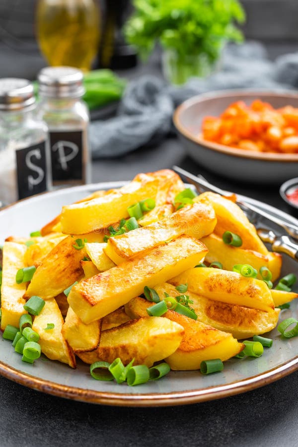 Baked, Fried Potato on Plate on Table Stock Photo - Image of green ...
