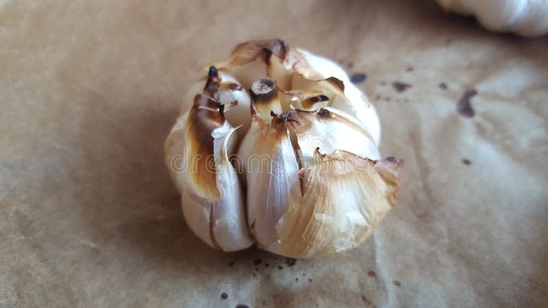 Baked garlic #2 stock image. Image of paper, oven, garlic - 64701603