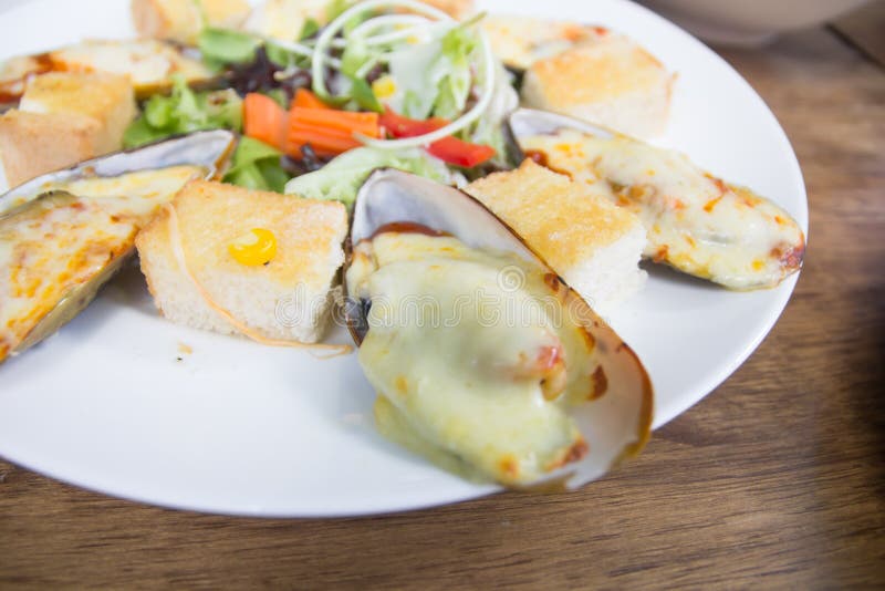 Baked mussels with cheese stock image. Image of appetizing - 148296823