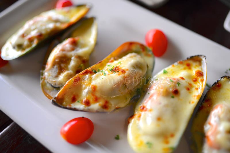 Baked mussels with cheese stock image. Image of green - 39481041