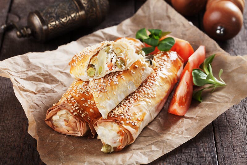 Baked phyllo pastry rolls stock photo. Image of seed - 69857196