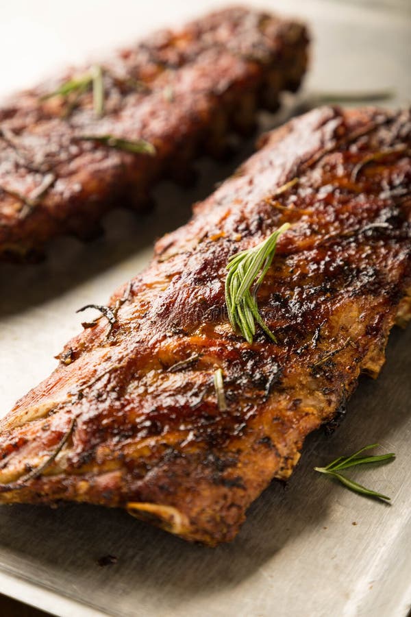 Baked pork ribs with sauce stock image. Image of board - 182624769