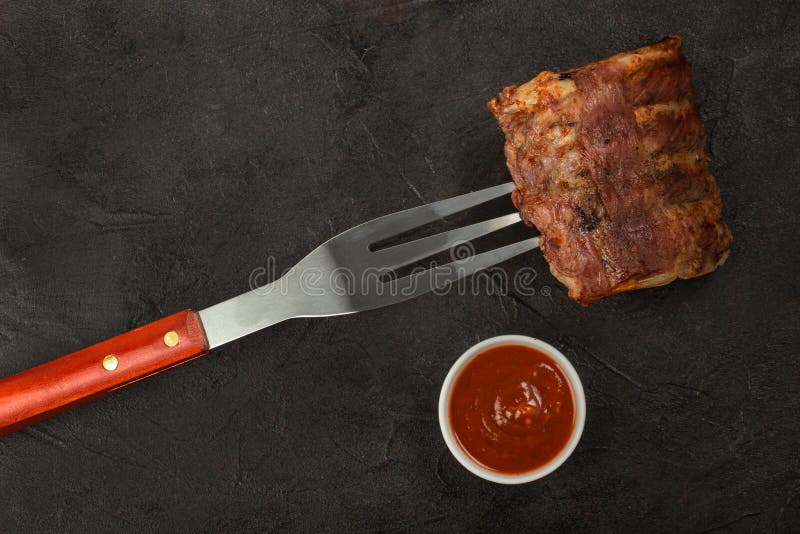 Baked Pork Strung on a Barbecue Fork with Red Sauce Stock Photo - Image ...