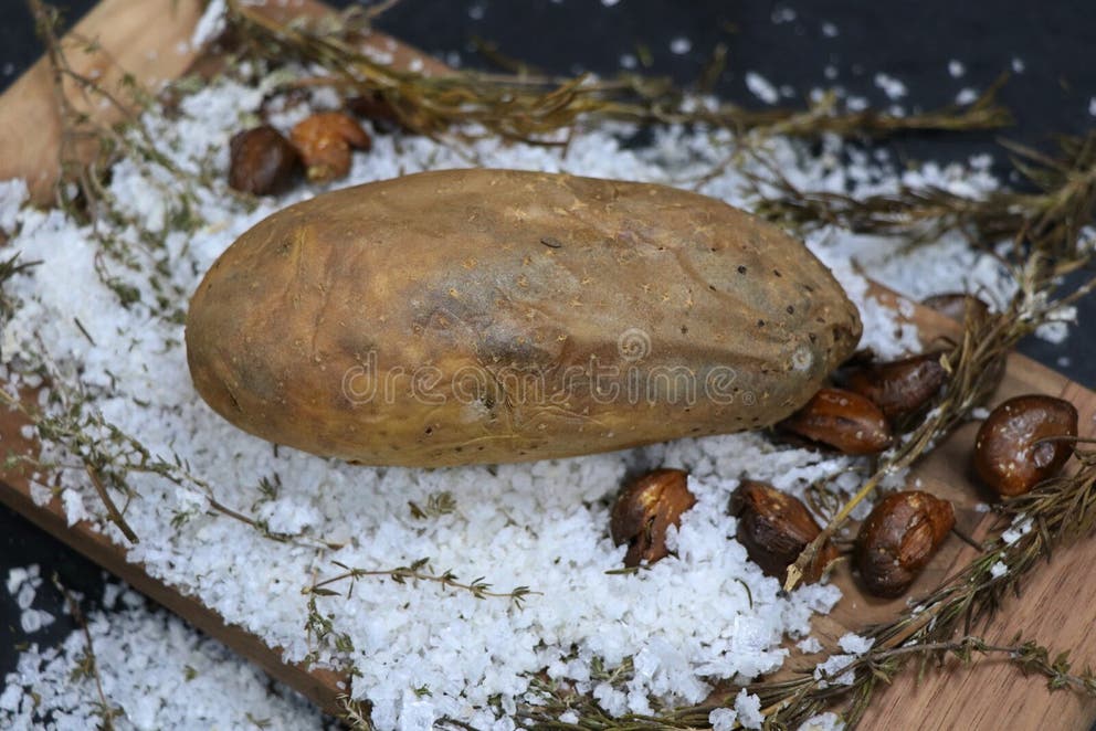 Baked potato on roack salt stock image. Image of cooked - 150537483