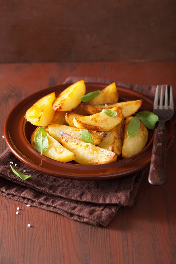 Baked Potato Wedges in Plate Over Brown Rustic Table Stock Image ...