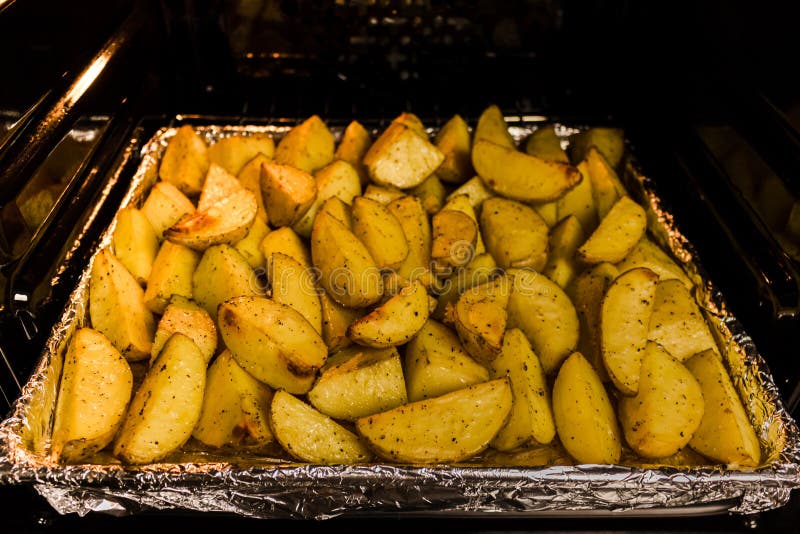Baked Potatoes in the Oven on a Kitchen Tray Stock Image - Image of ...