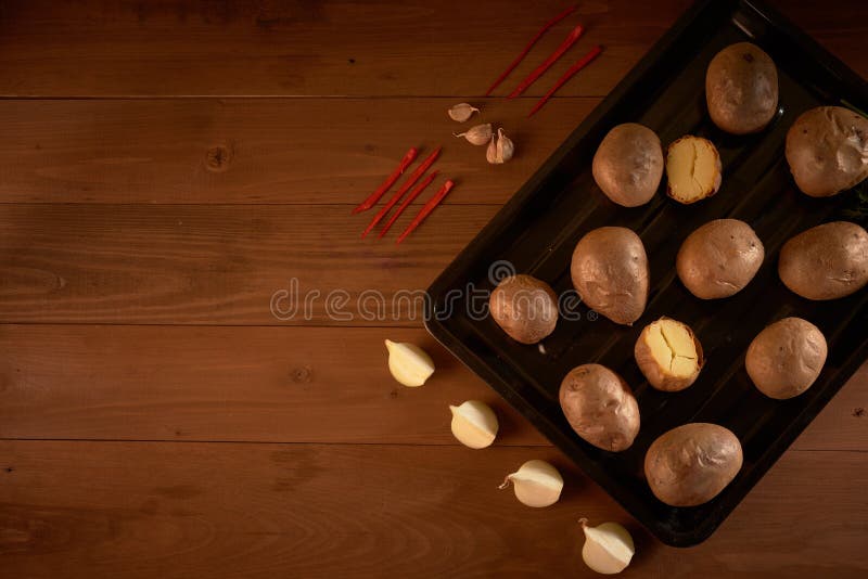 Baked potatoes on a table stock image. Image of cooked - 80280933
