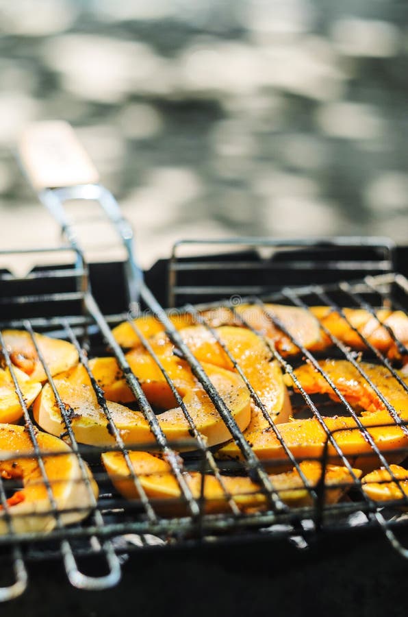 Baked Pumpkin Slices on the Grill Grid Stock Image - Image of coals ...