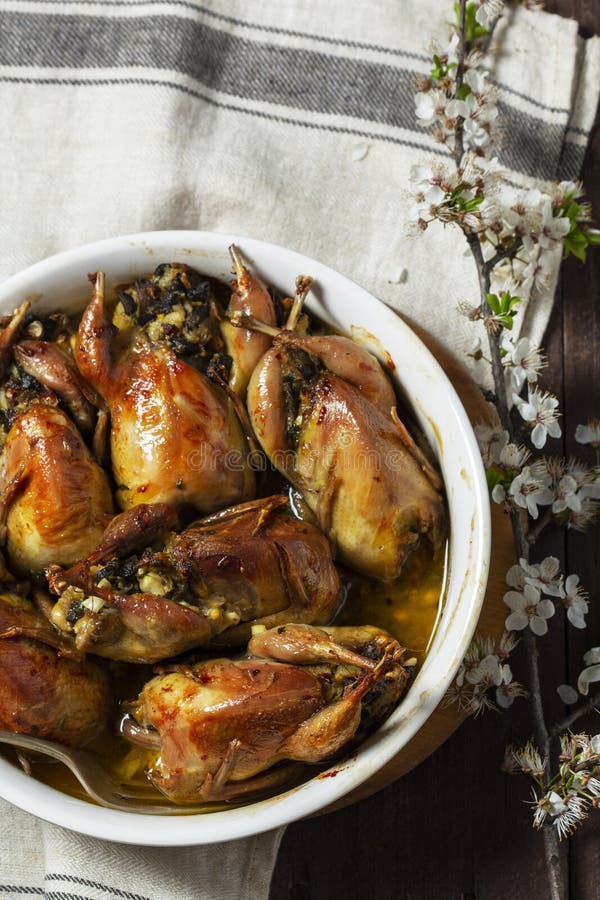 Baked Quail Stuffed with Mushrooms, Eggs and Bread in a Ceramic Form on ...