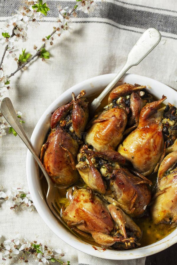 Baked Quail Stuffed with Mushrooms, Eggs and Bread in a Ceramic Form on ...