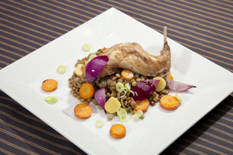 Baked Rabbit Leg with Lentil and Vegetable Stock Image - Image of food ...