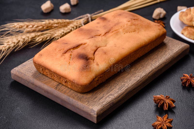 Baked Rectangular Cupcake with Raisins and Chocolate on a Dark Concrete ...