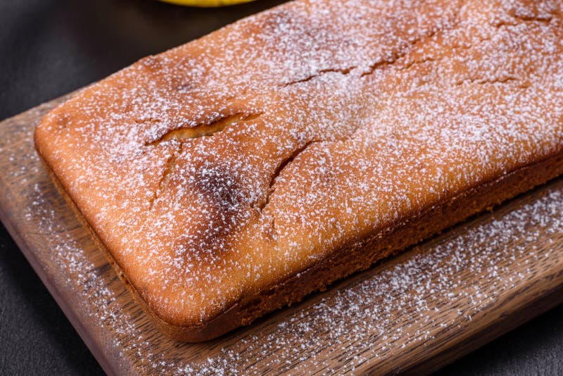 Baked Rectangular Cupcake with Raisins and Chocolate on a Dark Concrete ...