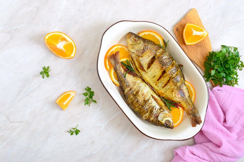 Baked Roach Fish with Vegetables and Oranges in a Ceramic Bowl. Top ...