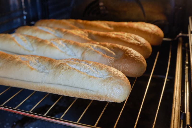 Baked rolls in the oven stock image. Image of baguettes - 216442143