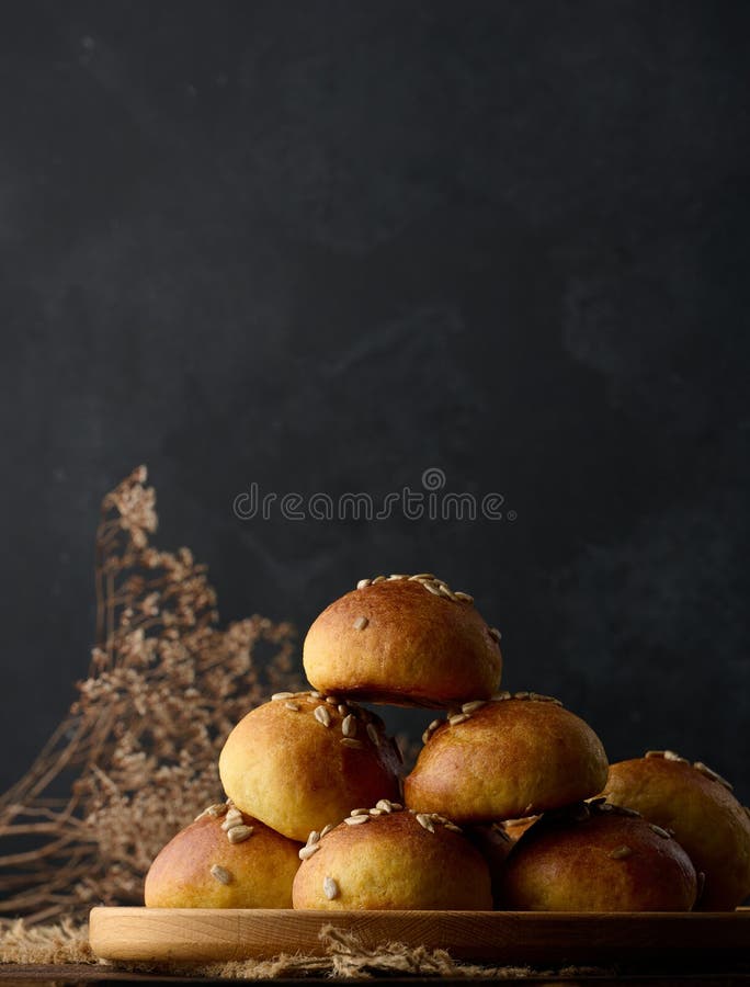 Baked Round Buns on a Wooden Table, Black Background Stock Image ...