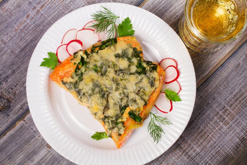 Baked Salmon with Spinach and Cheese. Fish on White Plate Stock Photo ...