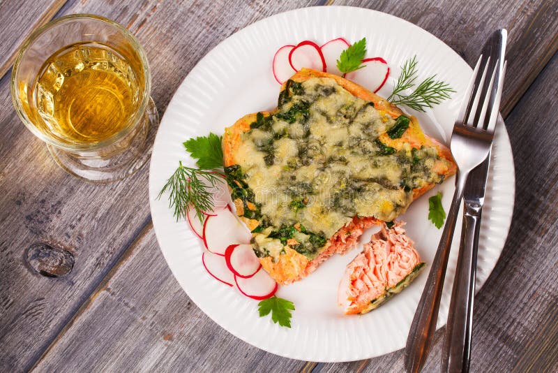 Baked Salmon with Spinach and Cheese. Fish on White Plate Stock Image ...