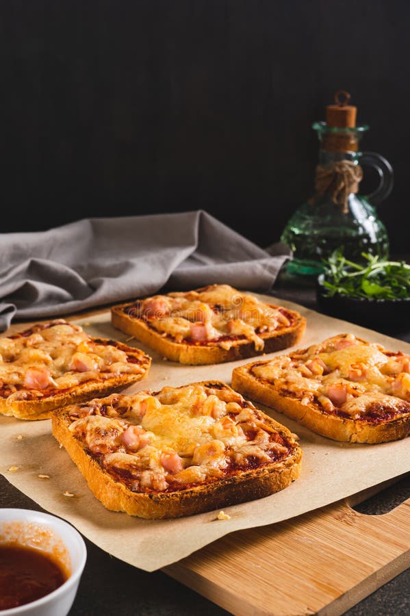 Baked Sandwiches with Bacon, Cheese and Tomato Sauce on a Board on a ...