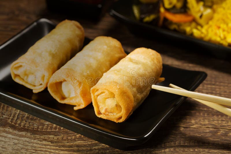 Baked Spring Rolls with Vegetables on a Black Plate Stock Image - Image ...