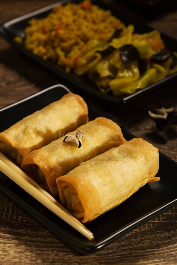 Baked Spring Rolls with Vegetables on a Black Plate Stock Image - Image ...