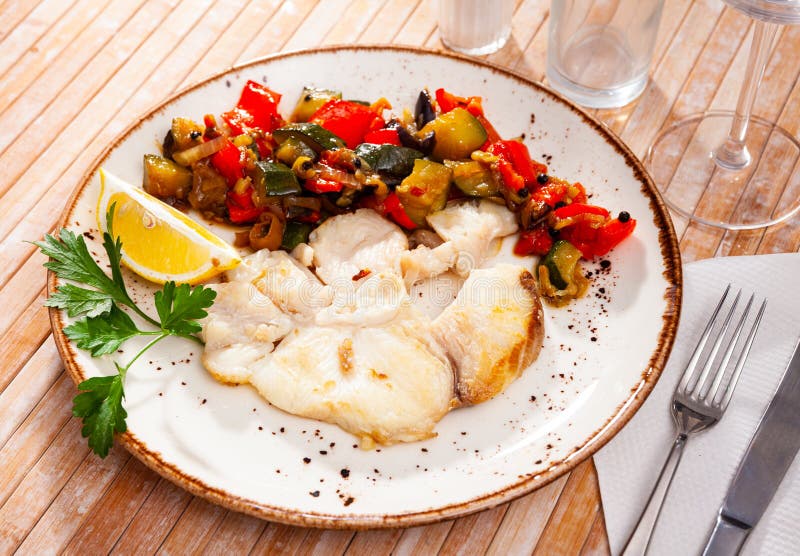 Baked Steak of Shark with Stewed Vegetables and Lemon Stock Photo ...