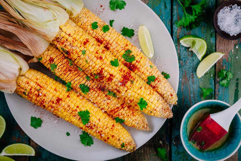 Baked Sweet Corn Cobs with Herb Butter and Lime Stock Photo - Image of ...