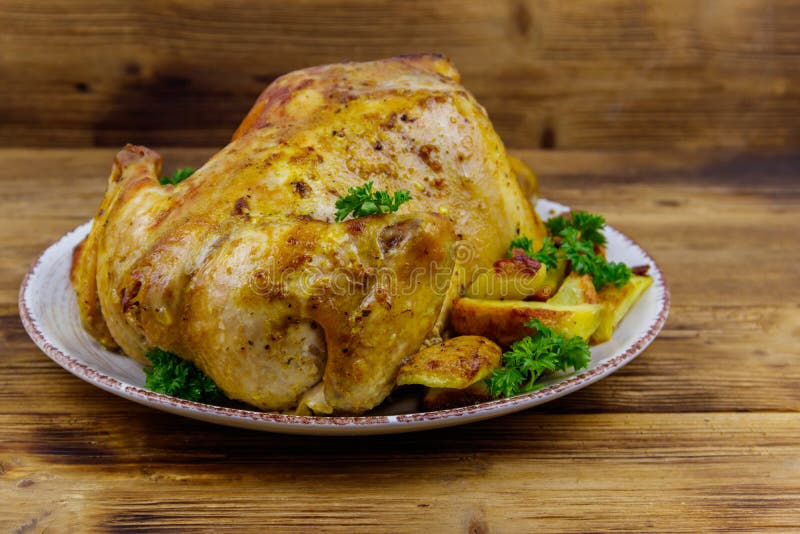 Baked Whole Chicken with Potato on Wooden Table Stock Photo - Image of ...