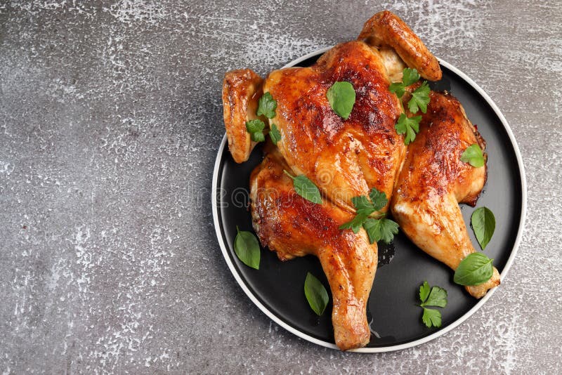 Baked Whole Chicken on a Round Plate on a Dark Background Stock Photo ...