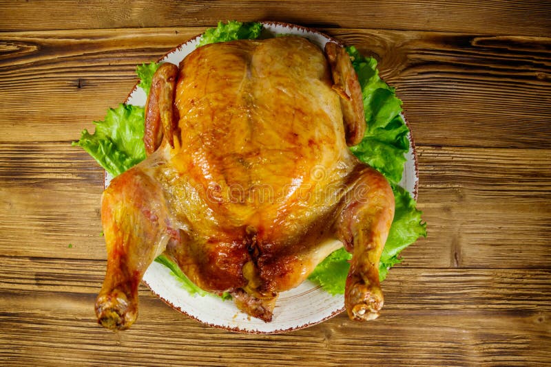 Baked Whole Chicken on Wooden Table. Top View Stock Photo - Image of ...
