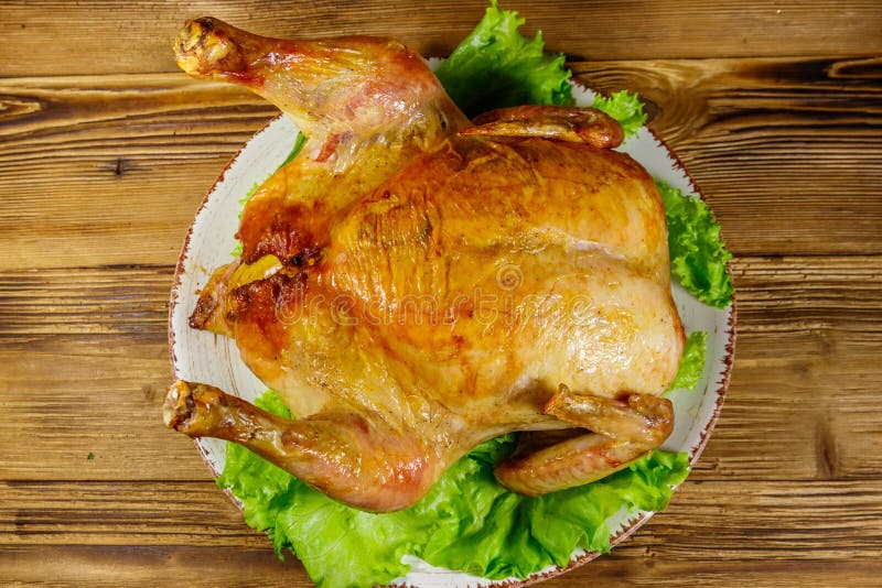 Baked Whole Chicken on Wooden Table. Top View Stock Photo - Image of ...