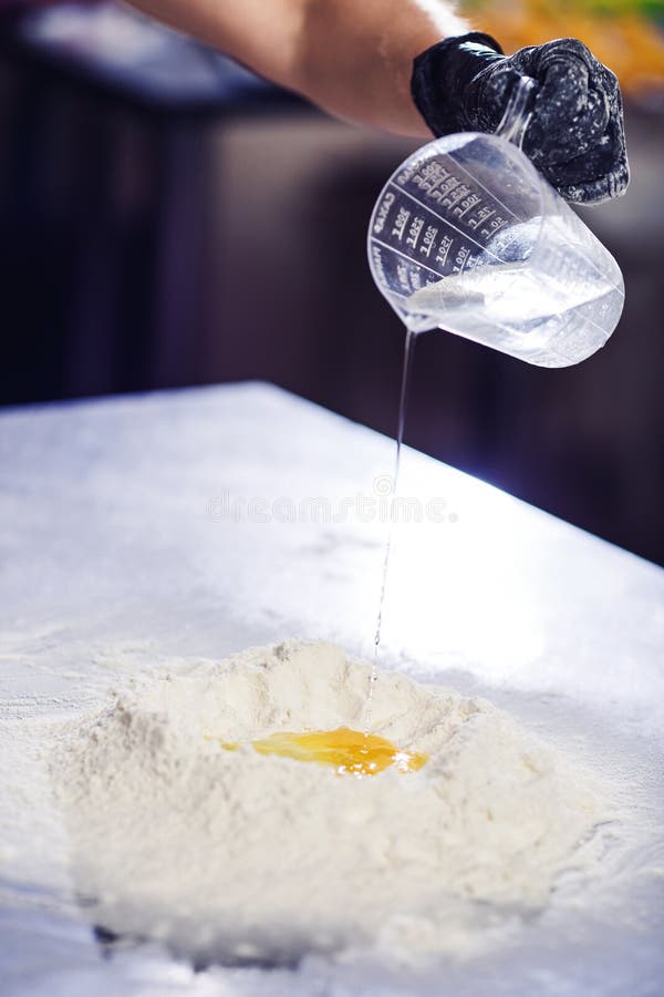 Baker Adds Water To Heap of Flour Stock Photo - Image of kitchen ...