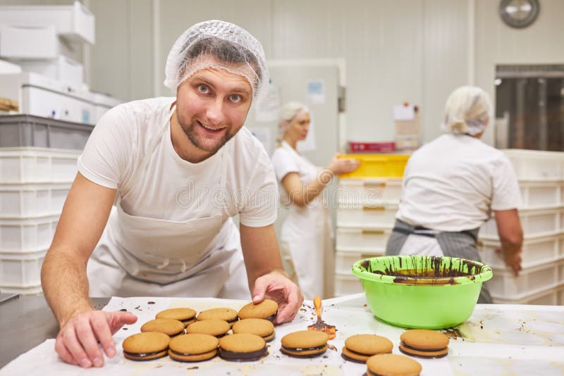 Baker Apprentice Decorates Double Biscuits with Chocolate Stock Image ...