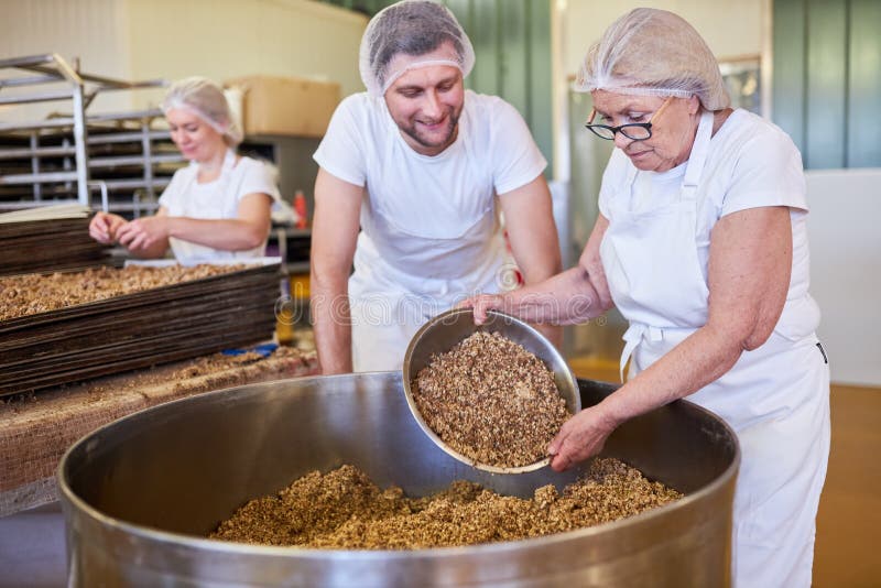 Baker Apprentice and Senior Baker Mixing Grains Stock Image - Image of ...