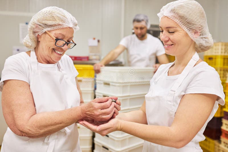 Baker Baking the Biscuit Together with an Apprentice Stock Photo ...
