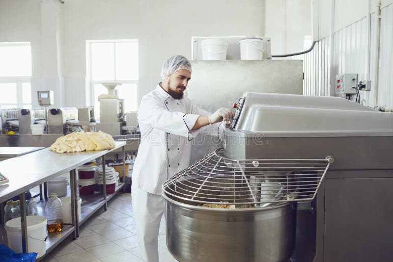 A Baker Makes the Dough on the Equipment in the Bakery Stock Image ...