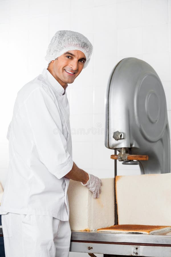 Baker with Bread Loaf Standing at Cutting Machine Stock Photo - Image ...